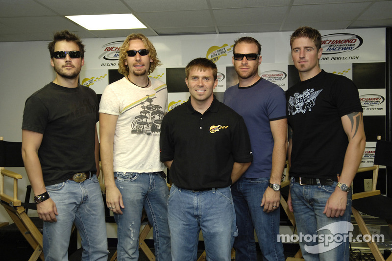 Scott Riggs stands with members of rock band Nickelback Daniel Adair ...